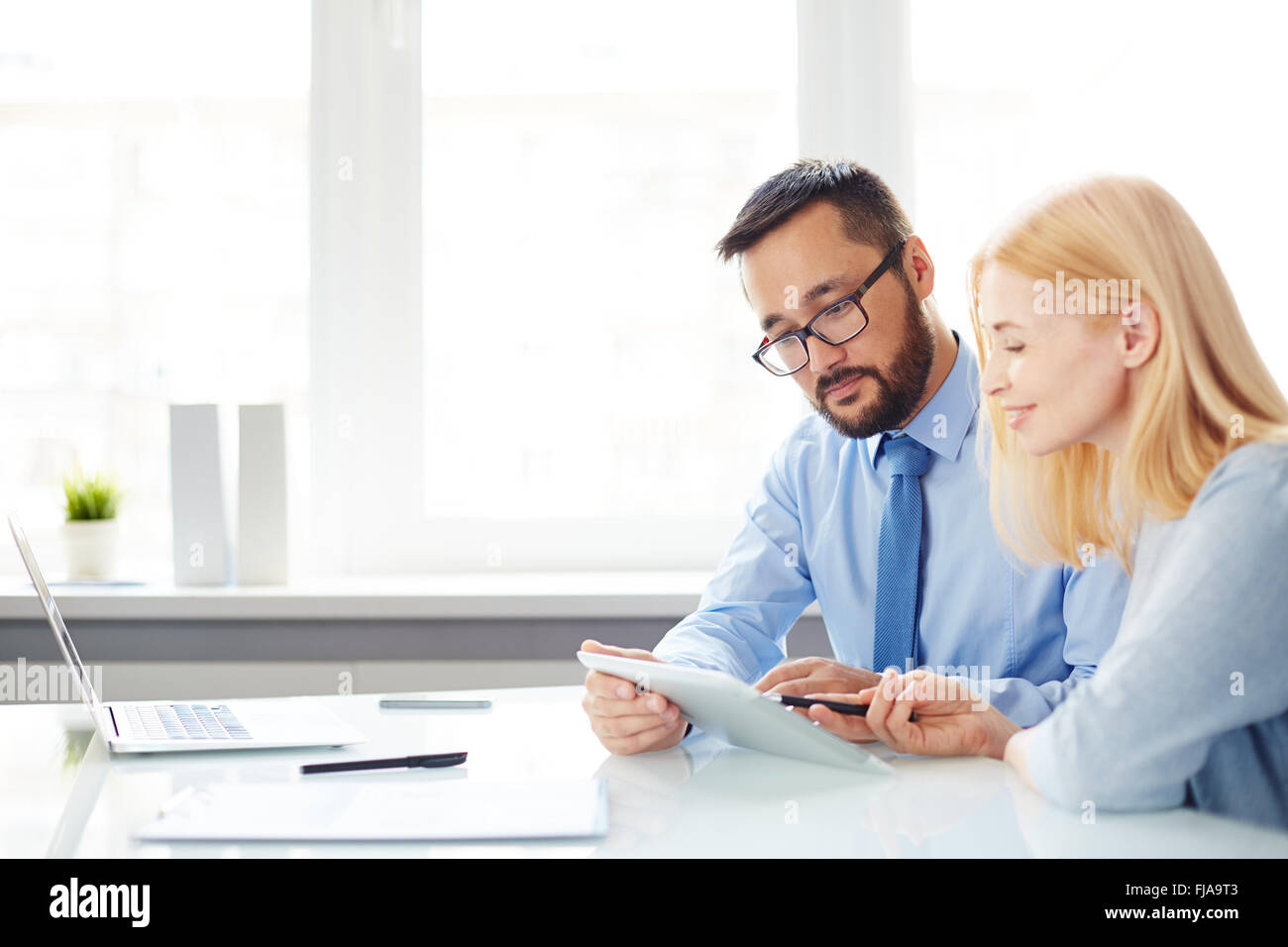 Two office workers discussing data at workplace Stock Photo - Alamy