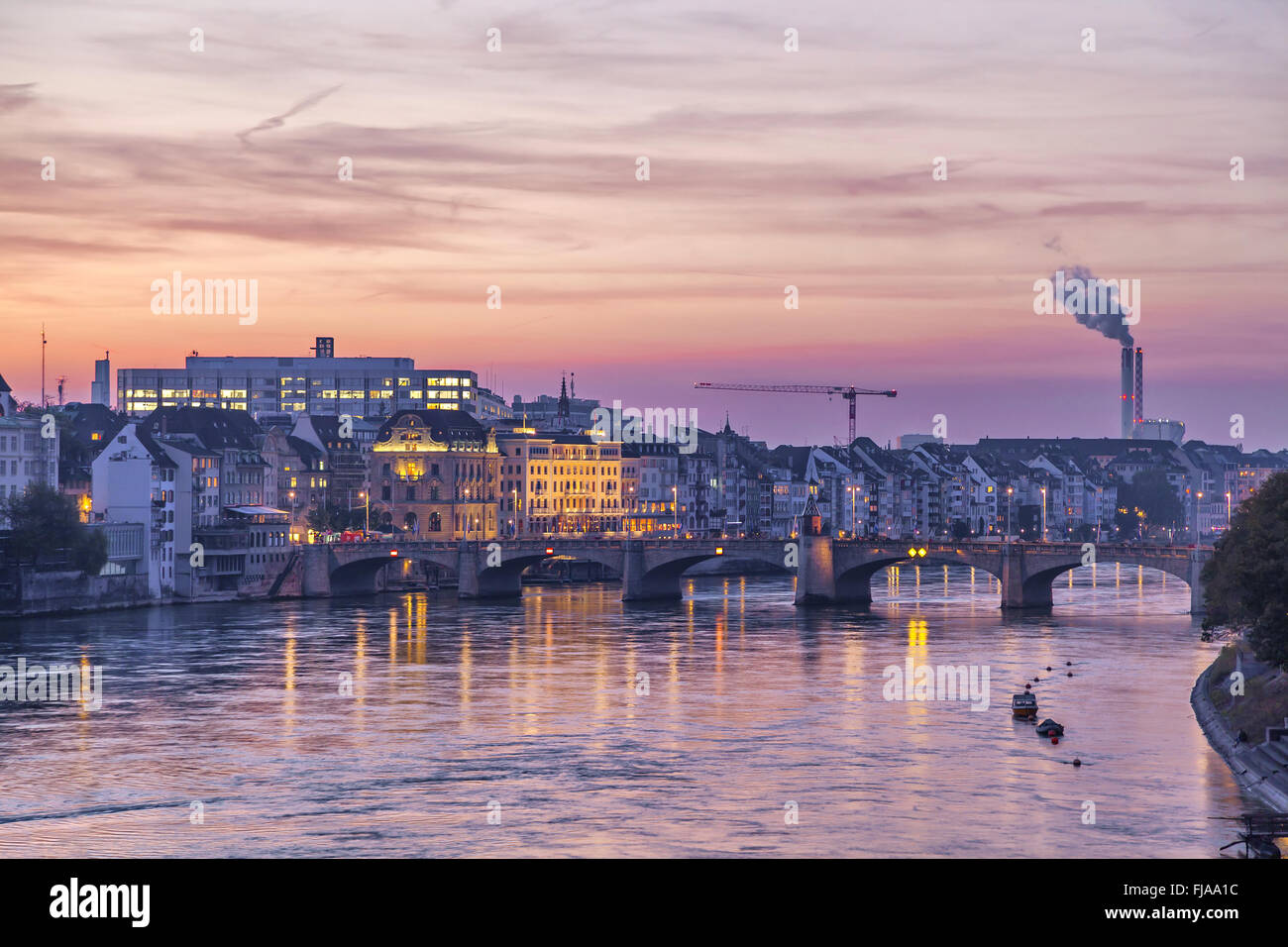 Mittlere bridge over Rhine river and city skyline at sunset, Basel ...