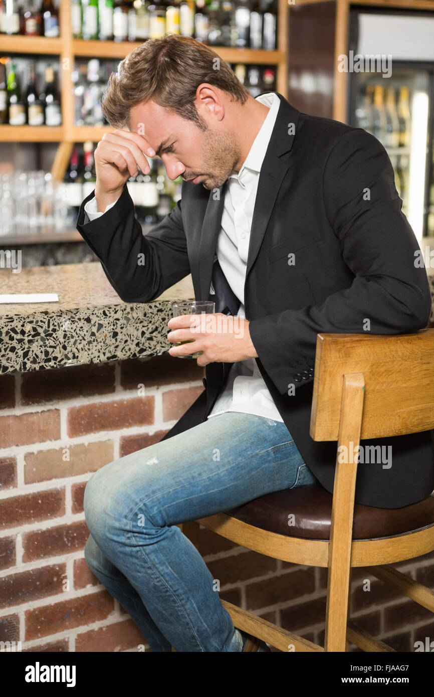 Tired man having a whiskey Stock Photo - Alamy