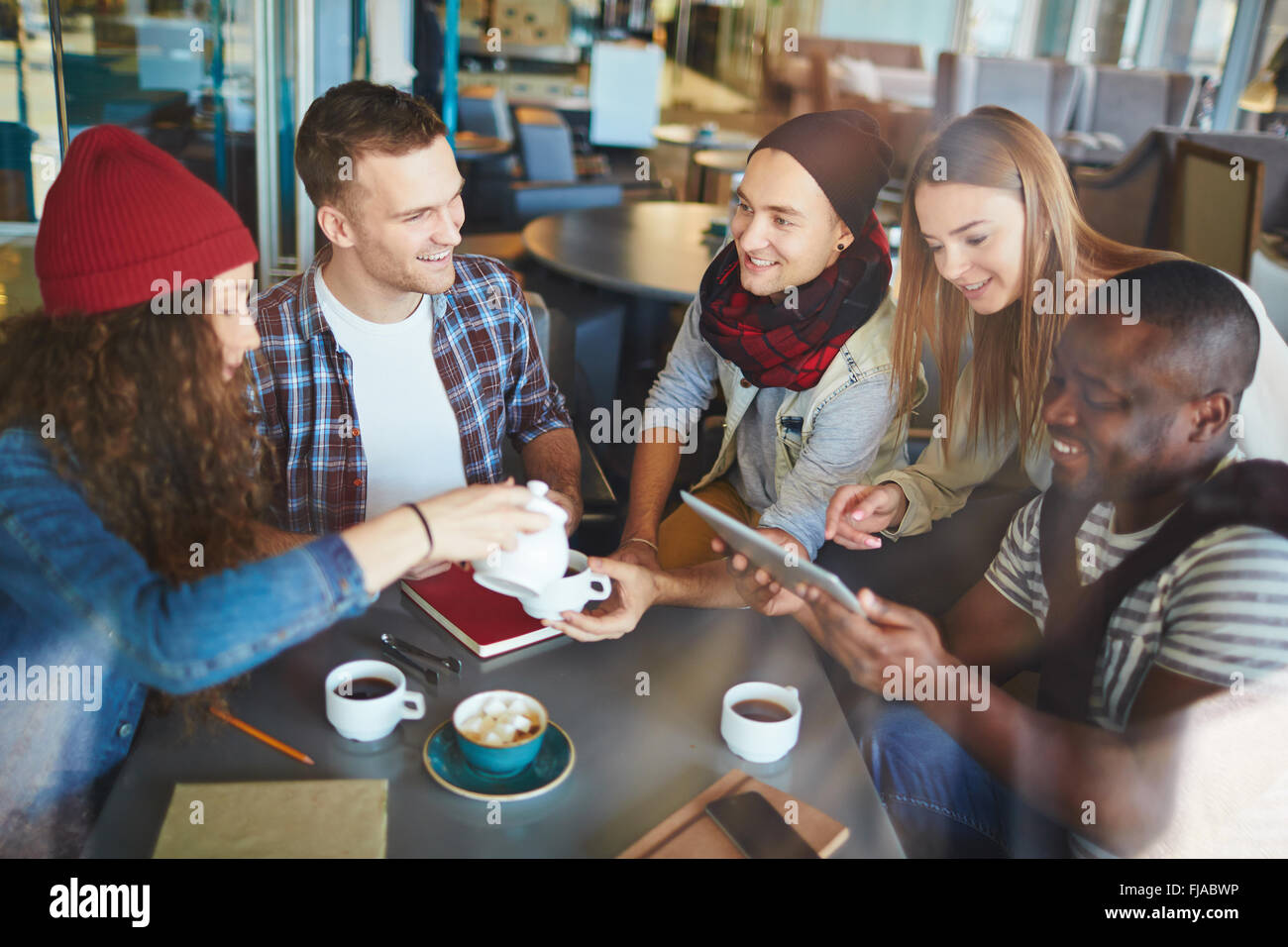 Friendly guys and girls having tea and chatting in cafe Stock Photo - Alamy