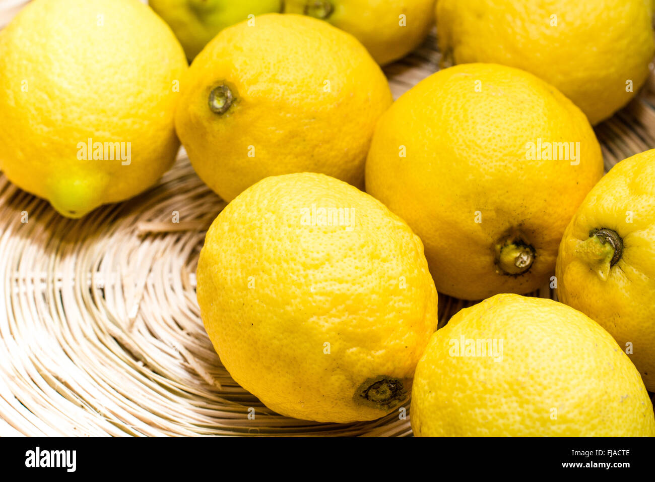 several lemons in a wicker tray Stock Photo - Alamy