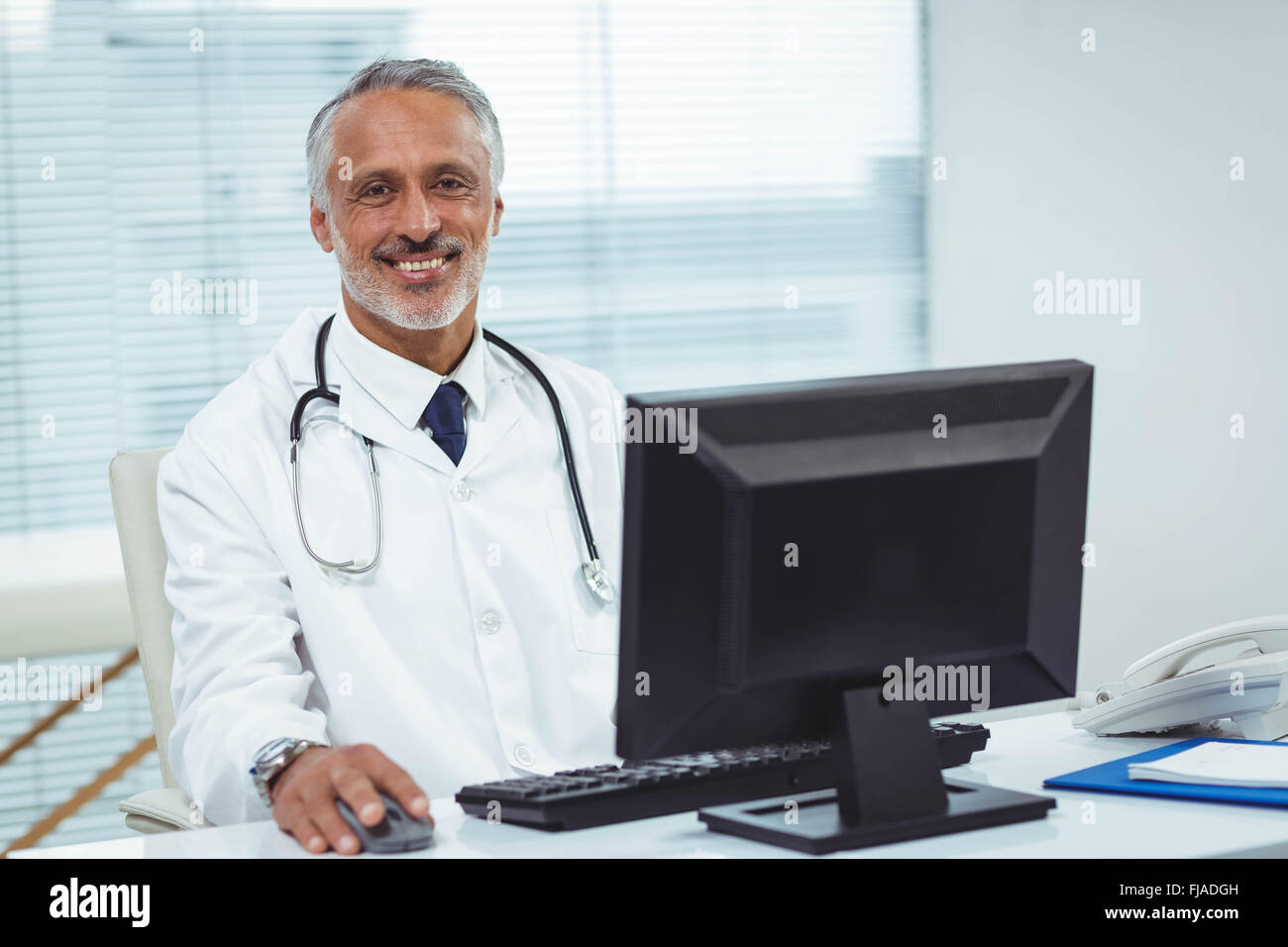 Doctor working on his computer Stock Photo - Alamy