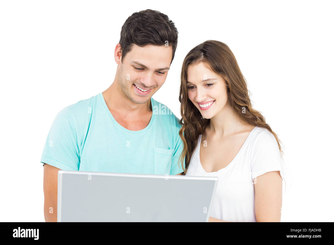 Happy couple using a laptop Stock Photo - Alamy