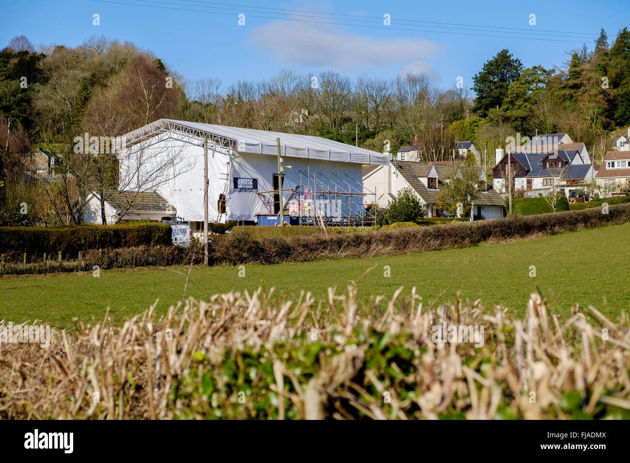 House covered in plastic sheeting while building work is going on ...