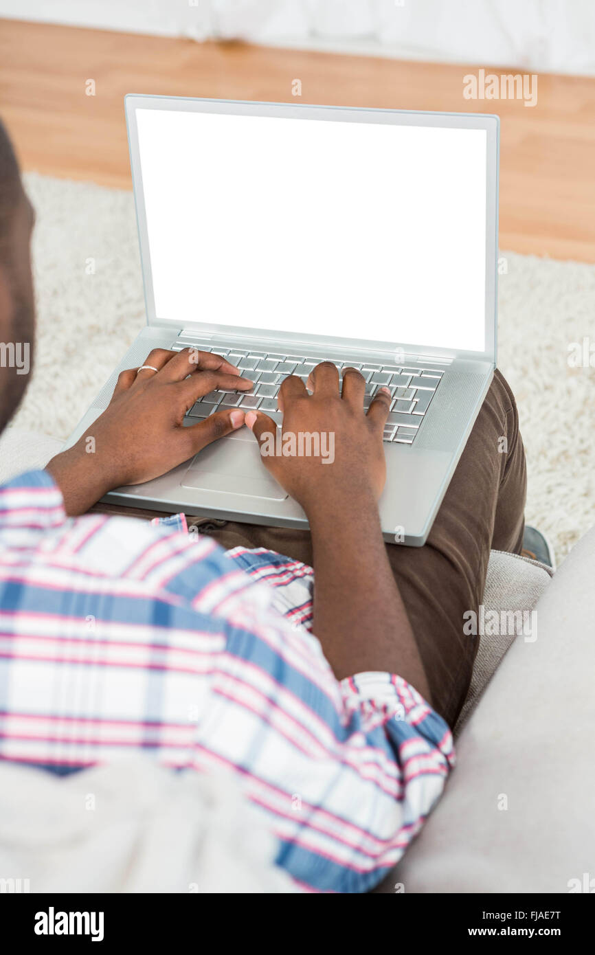 Black man home using laptop hi-res stock photography and images - Alamy