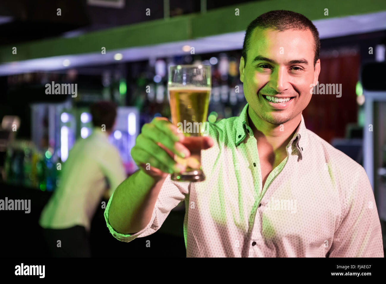 Man posing with glass of beer Stock Photo - Alamy