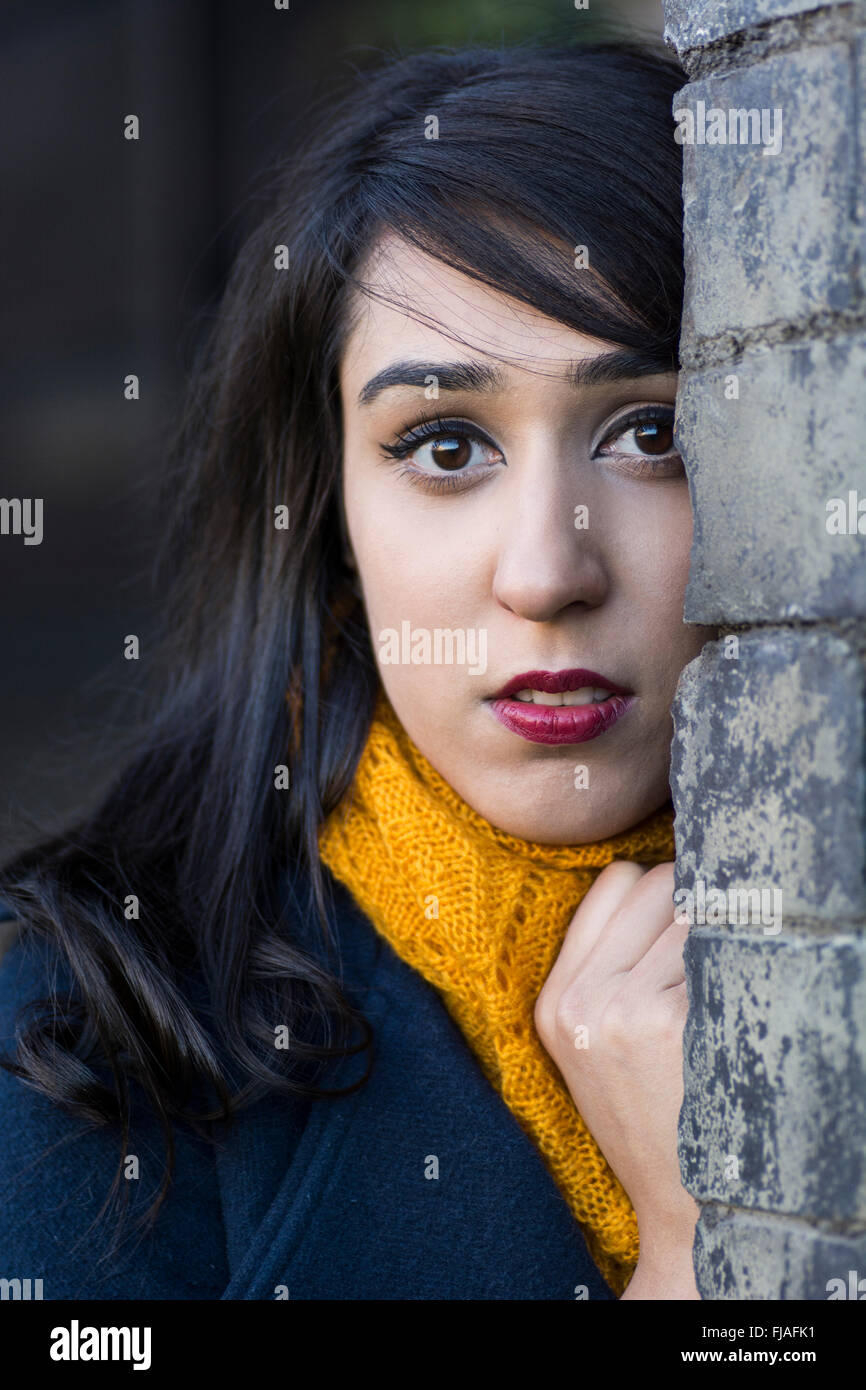 Woman hiding behind wall a watching hi-res stock photography and images ...