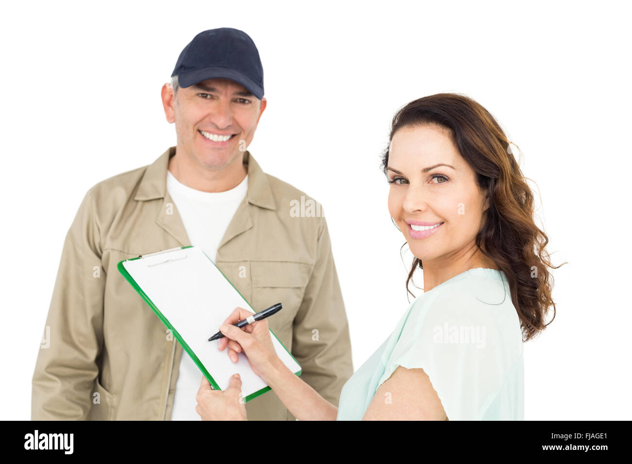Female customer signing on paper with delivery man Stock Photo - Alamy