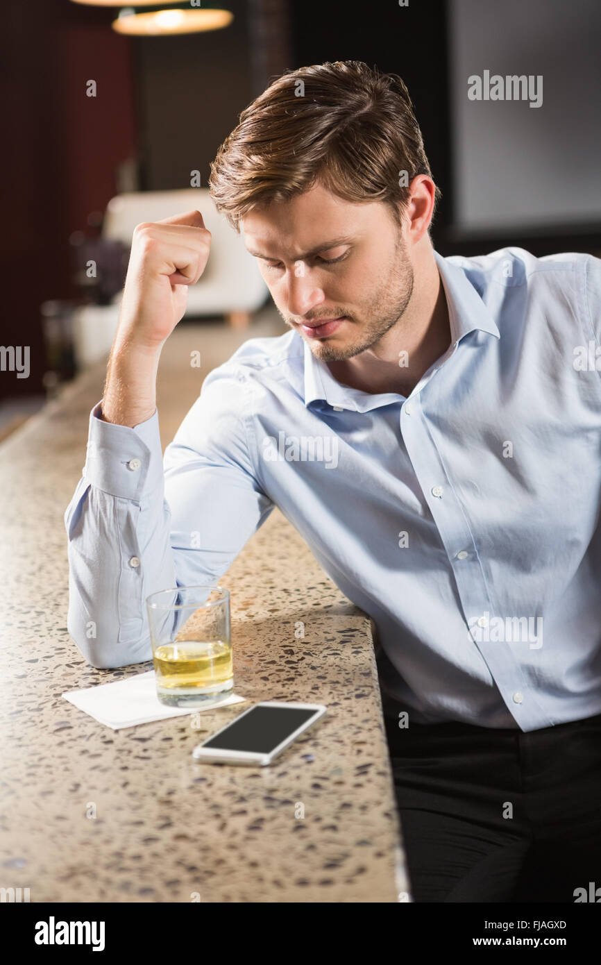 Tired man leaning his elbow on the counter Stock Photo - Alamy