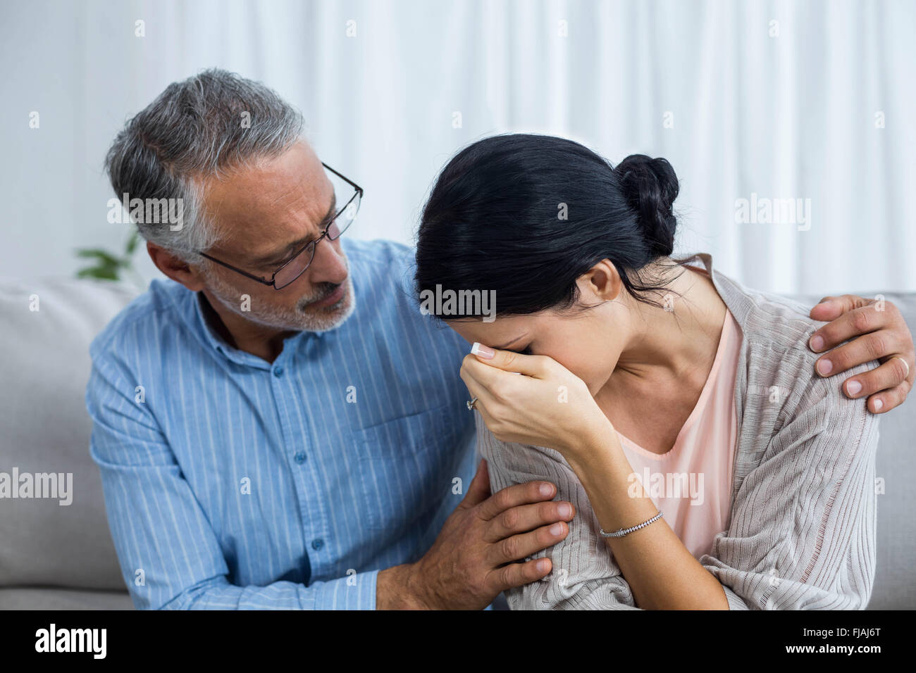 Therapist consoling a woman Stock Photo - Alamy