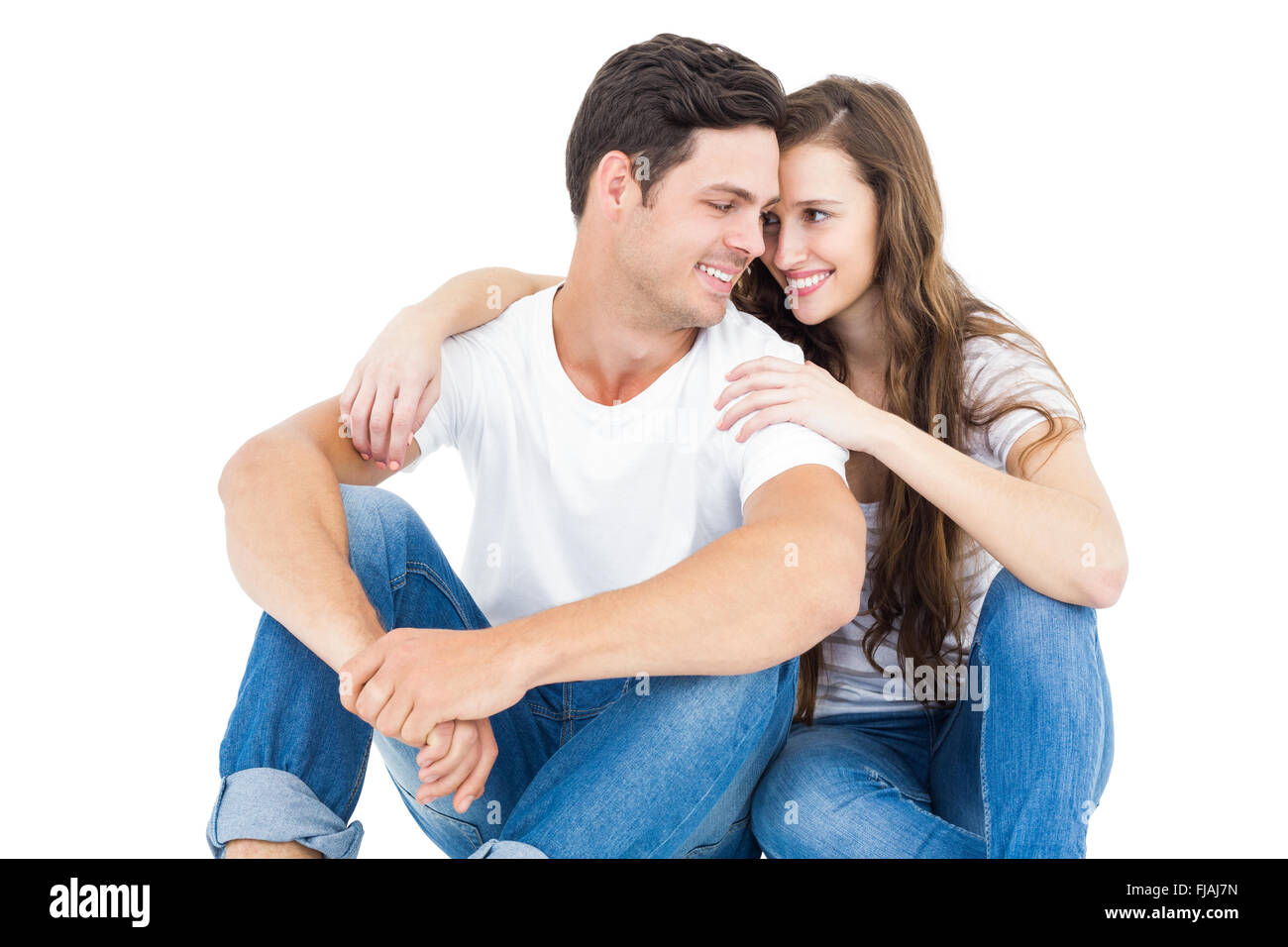 Young couple sitting on floor hugging Stock Photo - Alamy