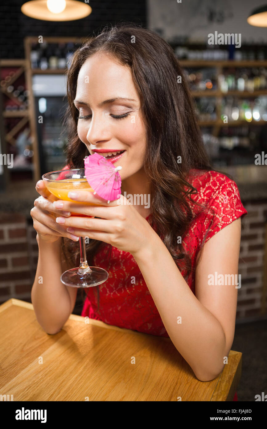 Pretty woman having a cocktail Stock Photo - Alamy