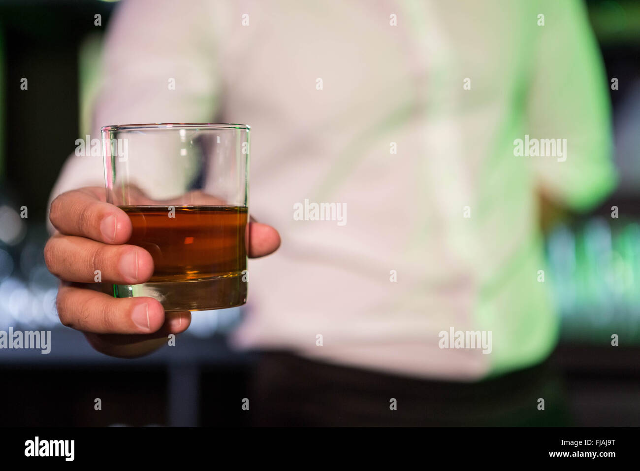 Bartender serving a glass of whiskey Stock Photo - Alamy