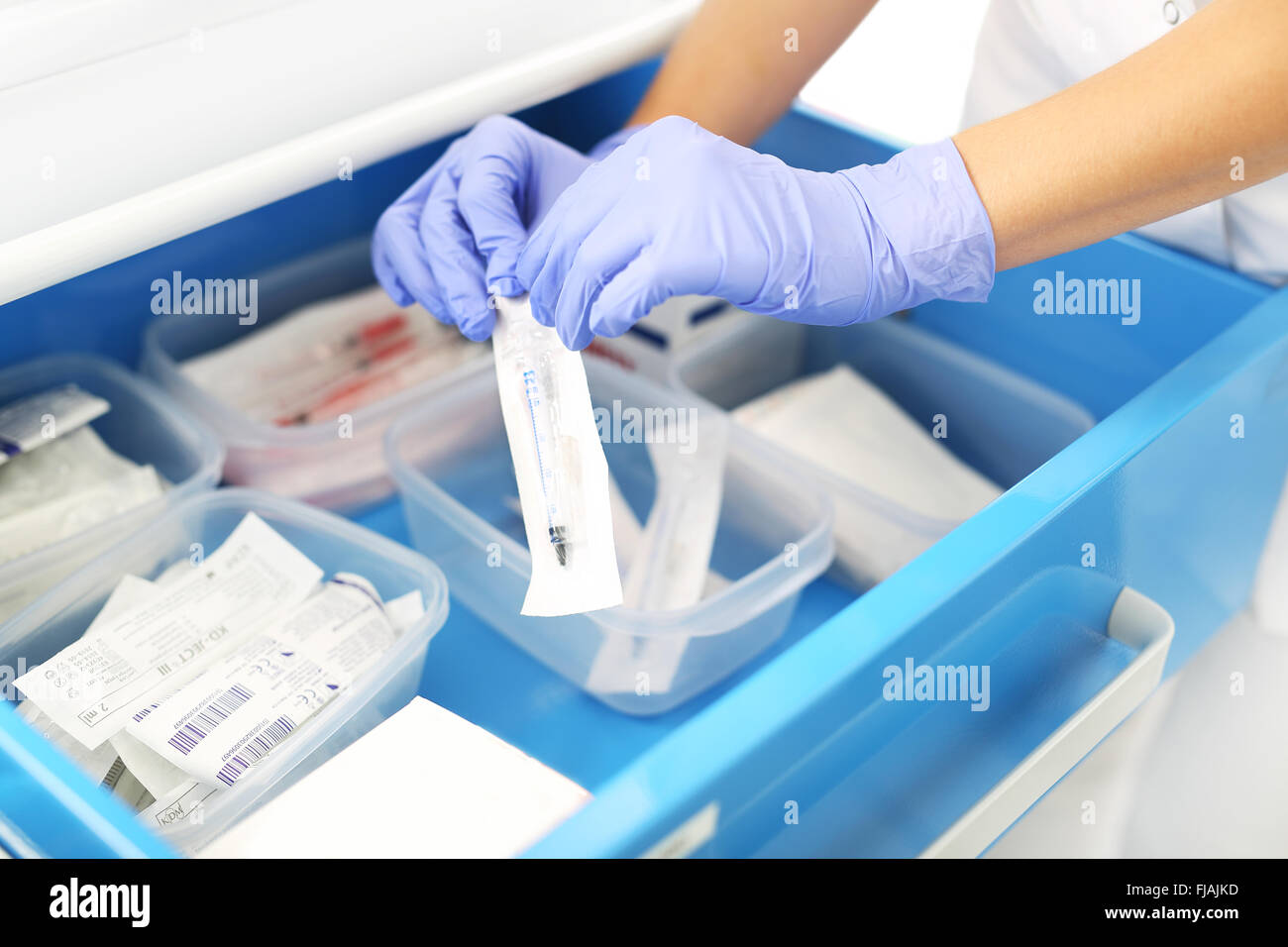 The nurse unpacks sterile syringe, Medical supplies. A nurse prepares ...