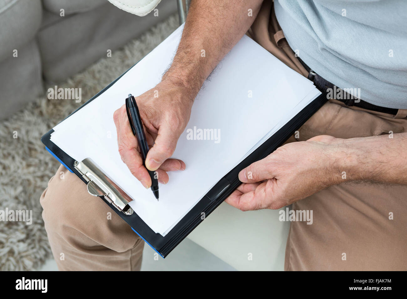 Man writing on notepad Stock Photo - Alamy