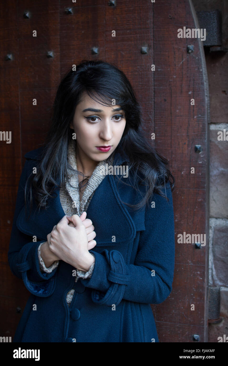 Young woman standing by the gate Stock Photo - Alamy