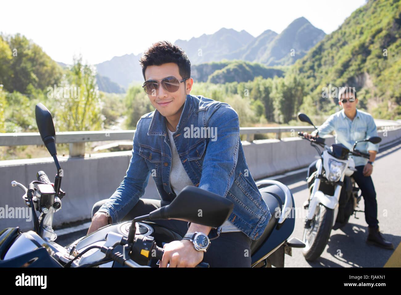 Young Chinese friends riding motorcycle together Stock Photo - Alamy