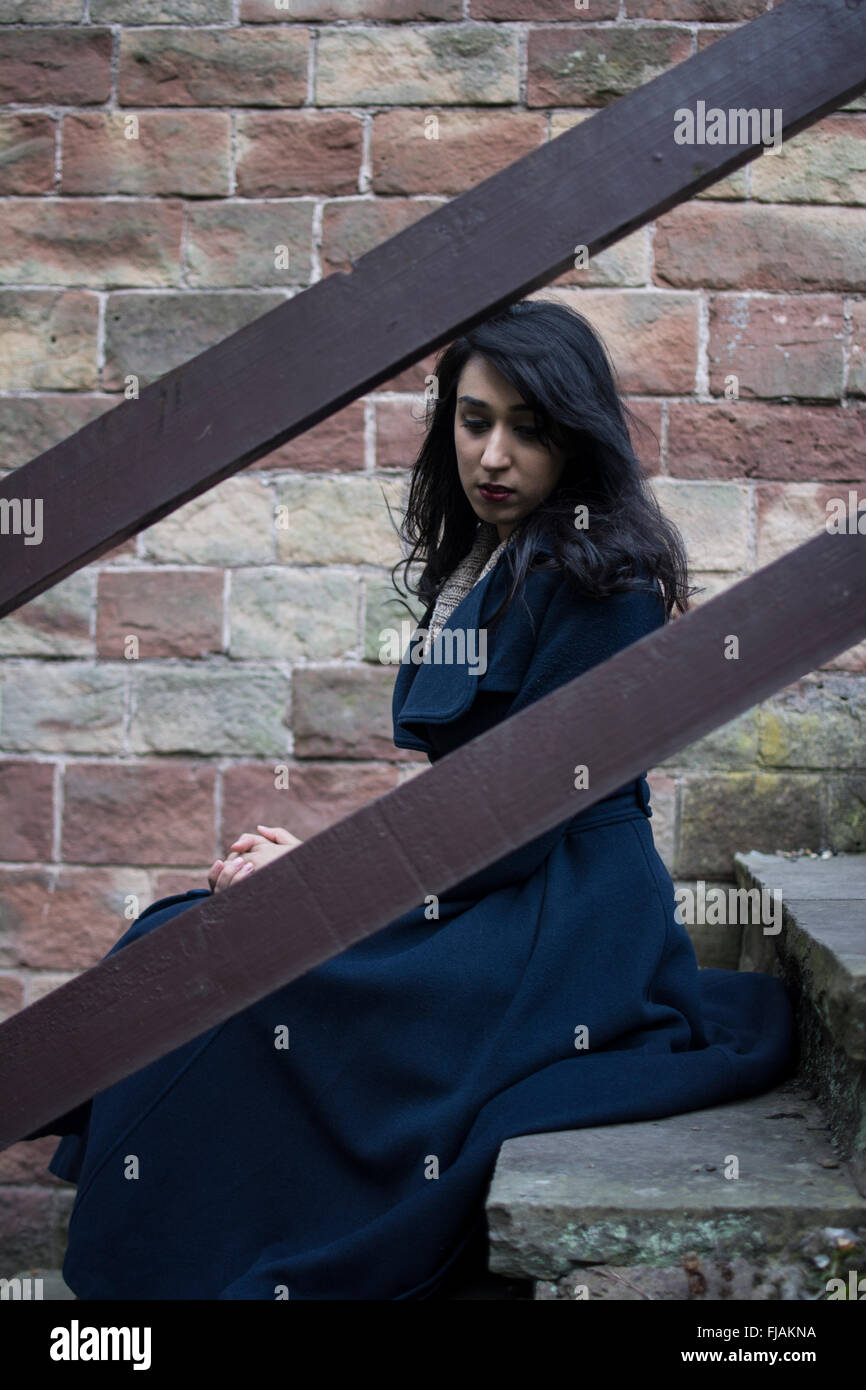 Sad girl sitting on stairs hi-res stock photography and images - Alamy
