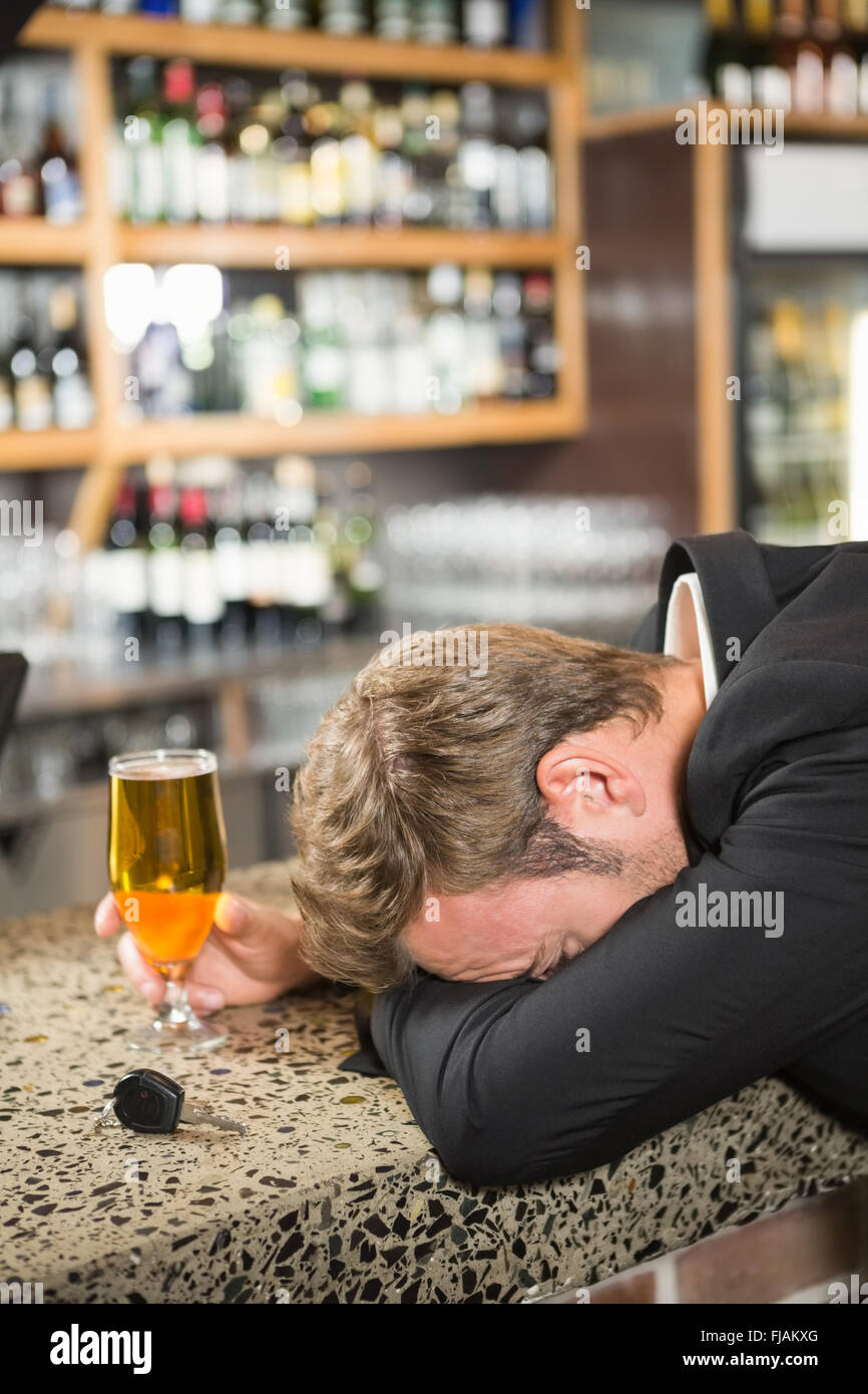 Tired man having a beer Stock Photo - Alamy