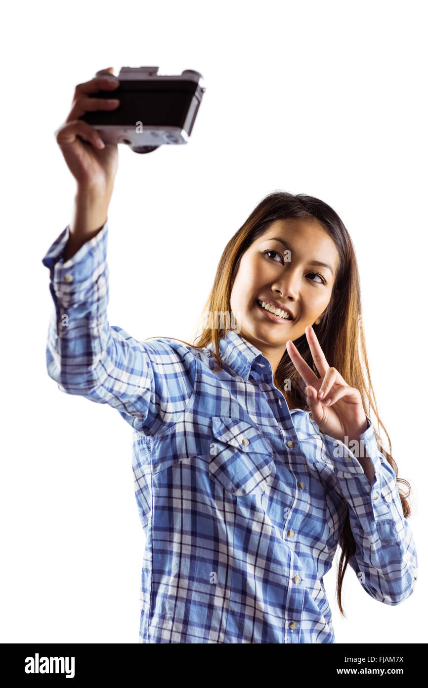 Smiling asian woman taking picture with camera Stock Photo - Alamy