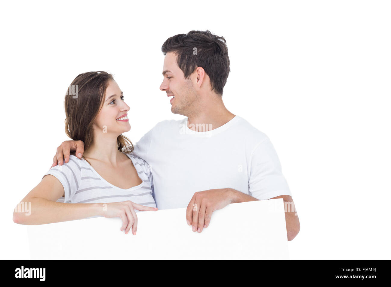 Happy couple holding a poster Stock Photo - Alamy