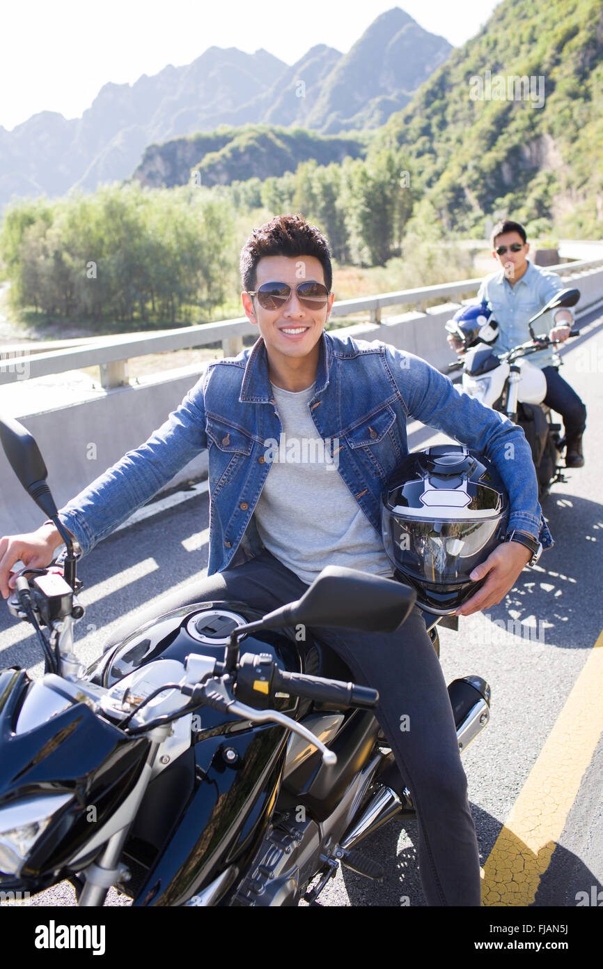 Young Chinese friends riding motorcycle together Stock Photo - Alamy