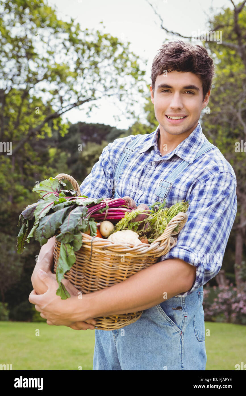 Man holding a basket of freshly harvested vegetables Stock Photo - Alamy