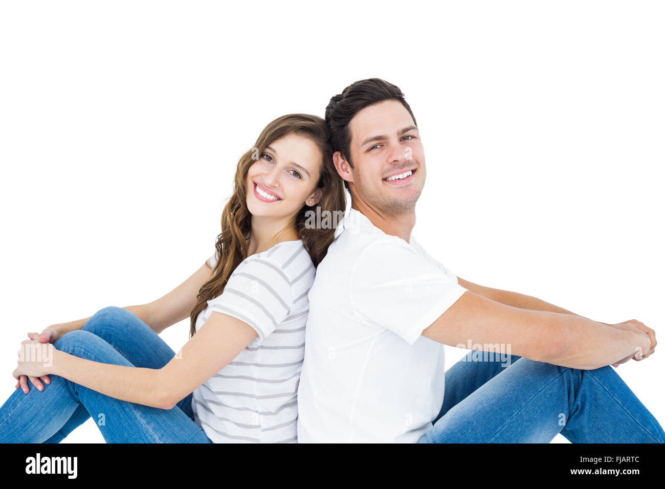 Young couple sitting on floor back to back Stock Photo - Alamy