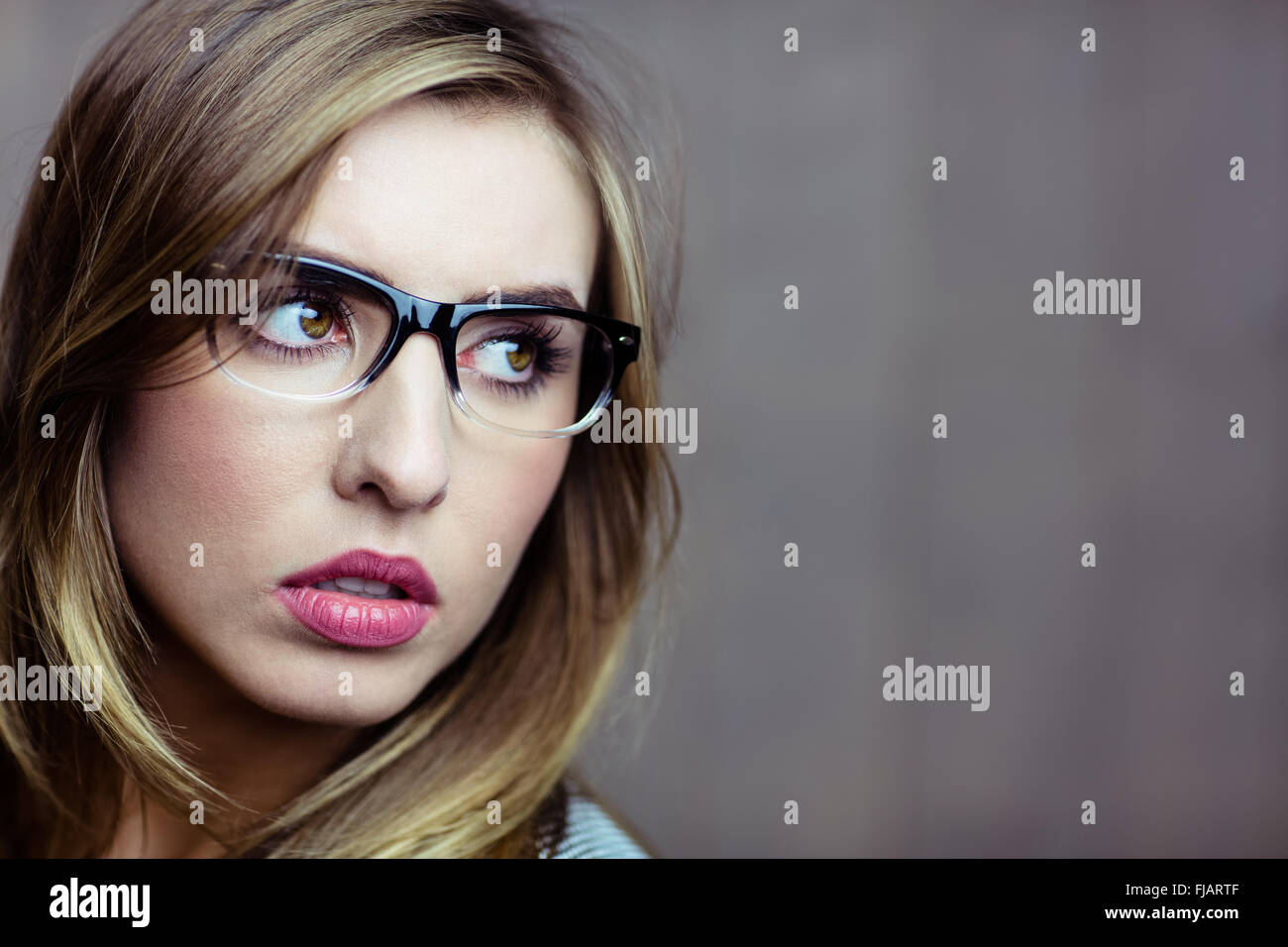 Pretty blonde woman day dreaming Stock Photo - Alamy