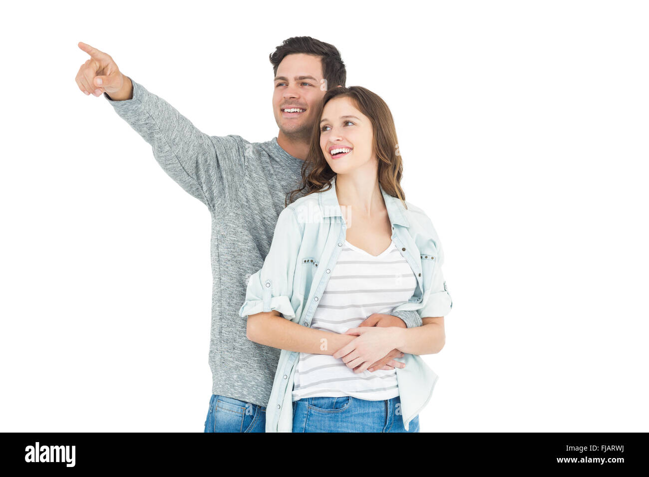 Couple embracing and pointing up Stock Photo - Alamy