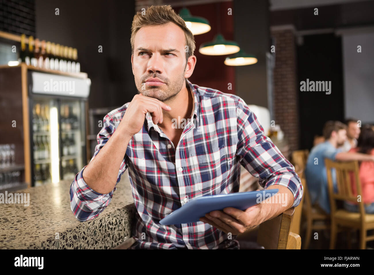 Handsome man using tablet computer Stock Photo - Alamy