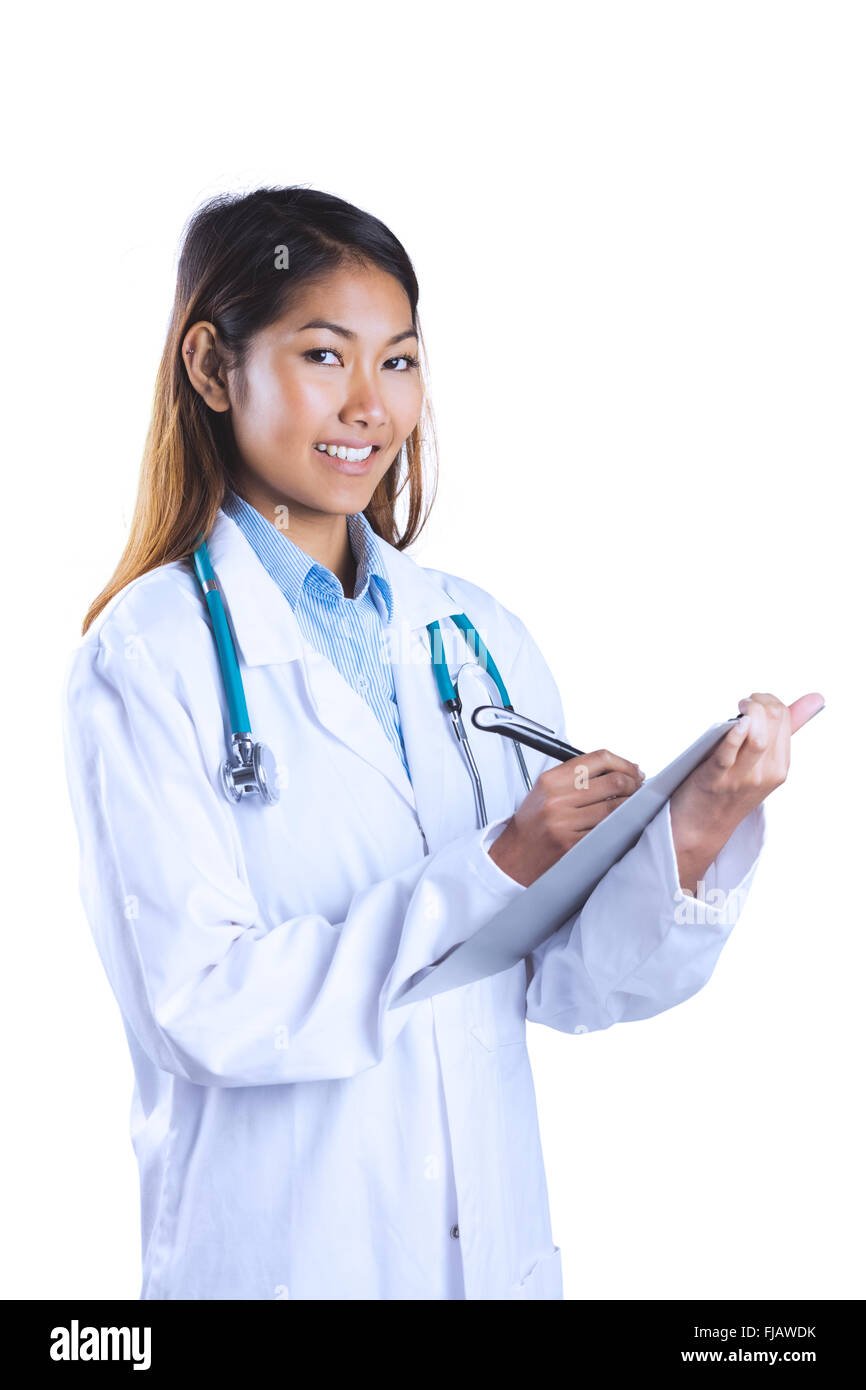 Asian doctor writing on files Stock Photo - Alamy