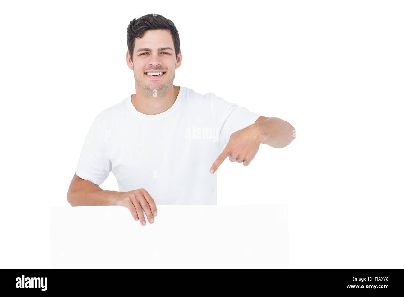 Handsome man pointing a white poster Stock Photo - Alamy