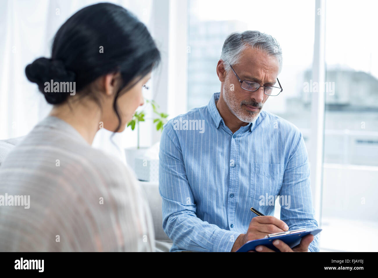 Therapist consoling a woman Stock Photo - Alamy