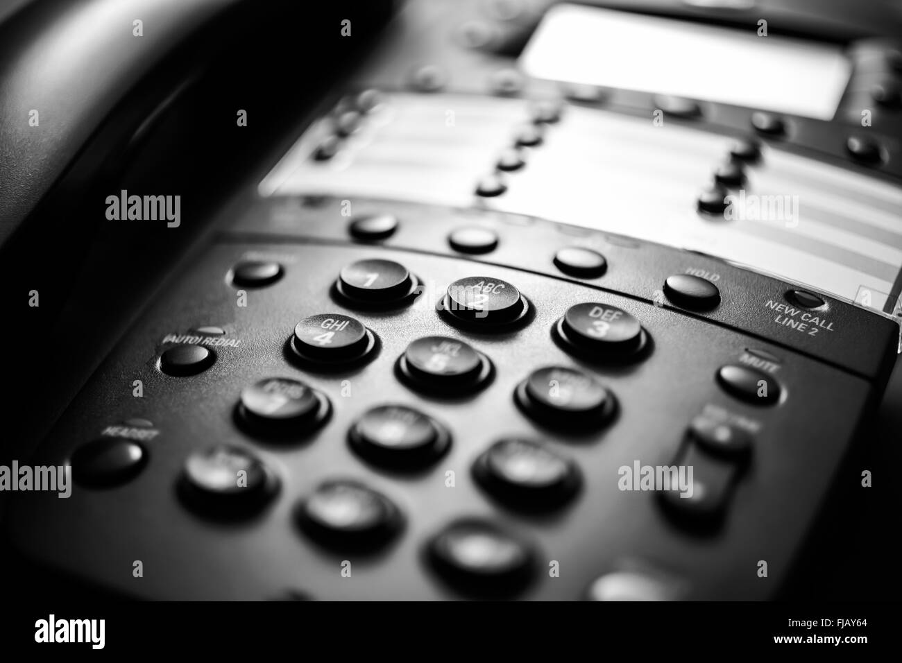 Modern black business landline telephone with number keypad close-up ...