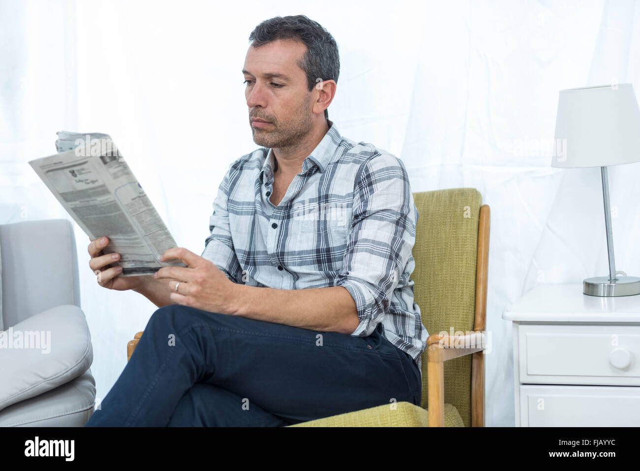 Man sitting on a chair Stock Photo - Alamy