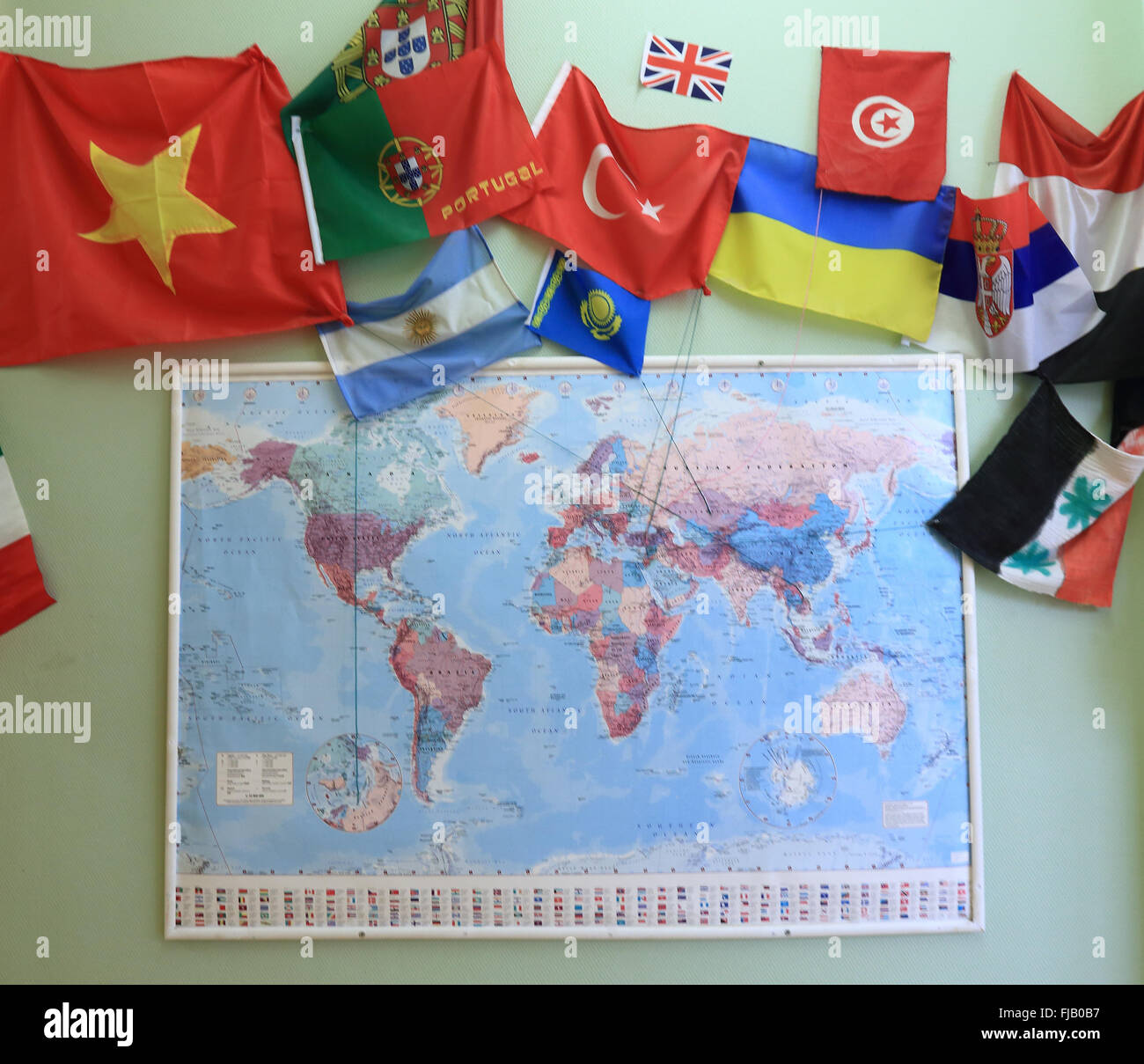 Children have decorated a world map with flags form different countries ...