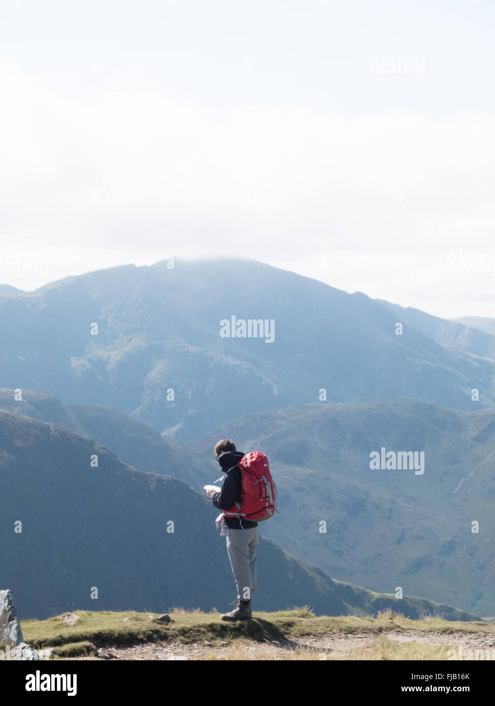 A Hiker checking the map in the lakes Stock Photo - Alamy