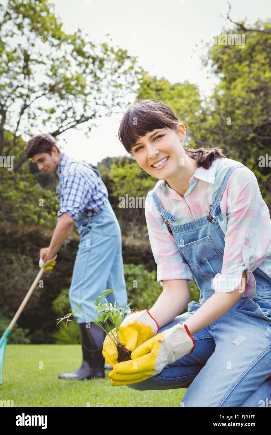 Young woman planting a sapling Stock Photo - Alamy