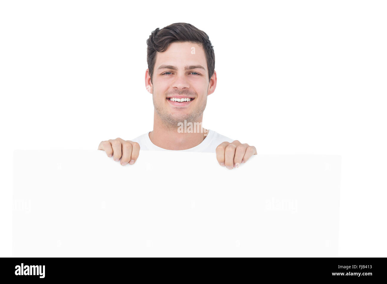 Handsome man holding a white poster Stock Photo - Alamy