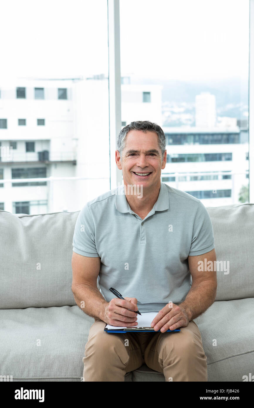 Sitting man writing hi-res stock photography and images - Alamy