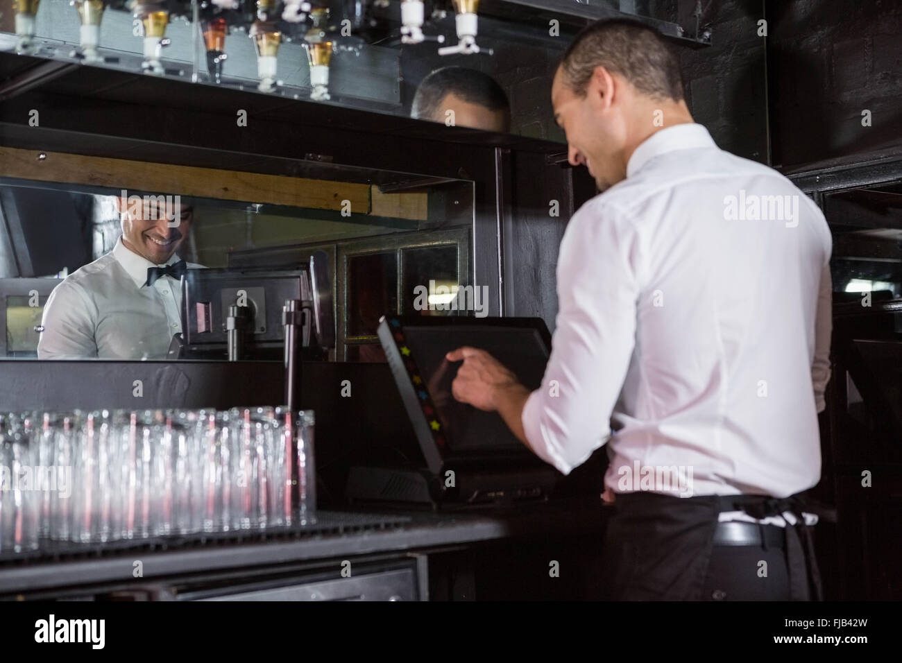 Waiter preparing a bill Stock Photo - Alamy