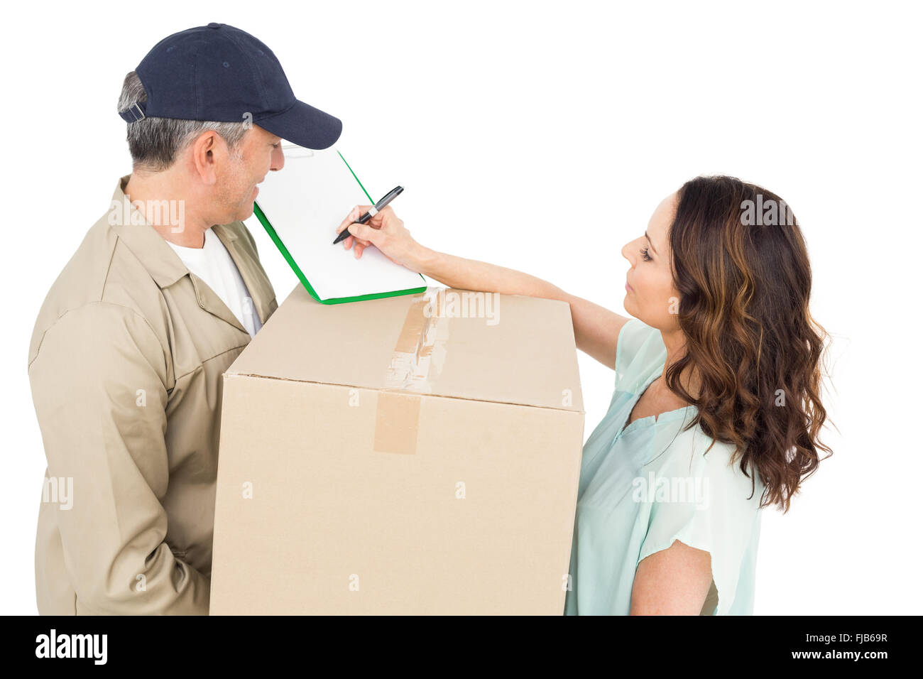 Female customer signing on paper with delivery man Stock Photo - Alamy