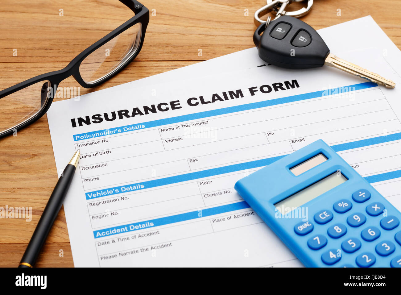 Car insurance claim form with pen and car key on wood desk Stock Photo ...