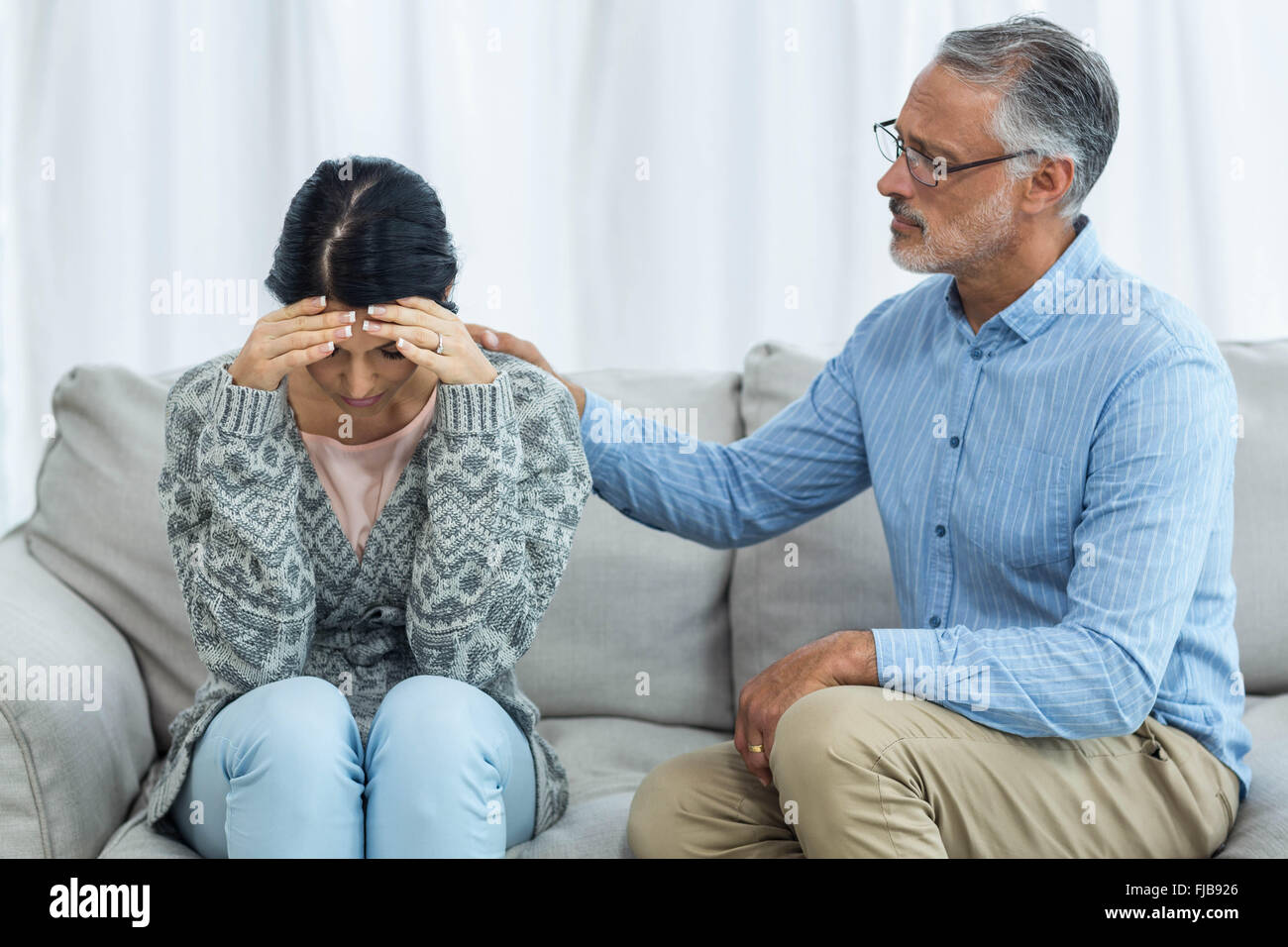 Therapist consoling a woman Stock Photo - Alamy