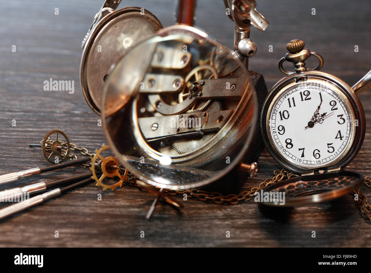 Hour workshop. Vintage still life with ancient silver pocket watch ...