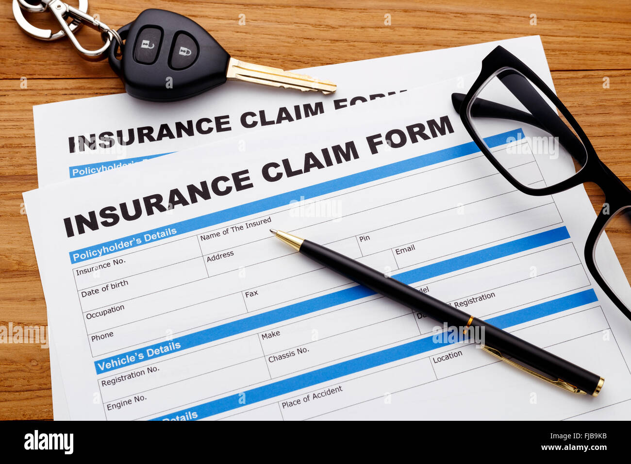 Car insurance claim concept with pen and eyeglasses on wood desk Stock ...