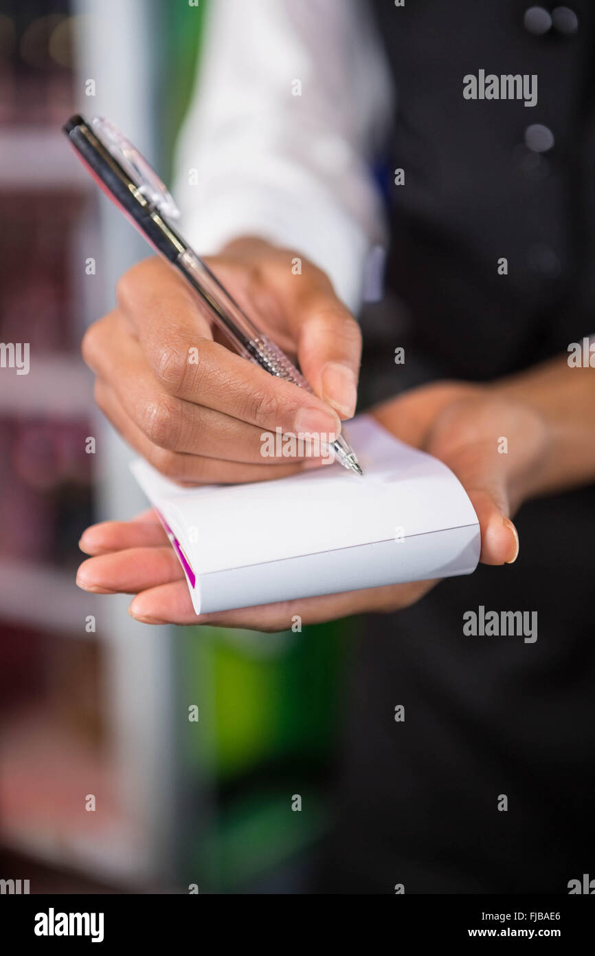 Waiter writing down an order Stock Photo - Alamy