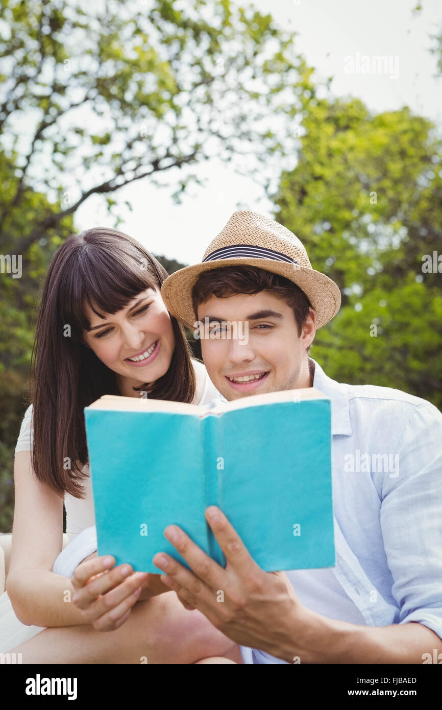 Young couple reading a novel Stock Photo - Alamy
