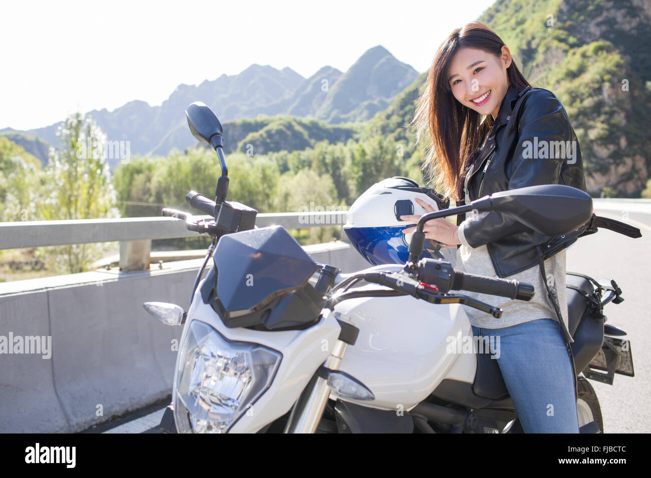 Young chinese woman riding motorcycle hi-res stock photography and ...